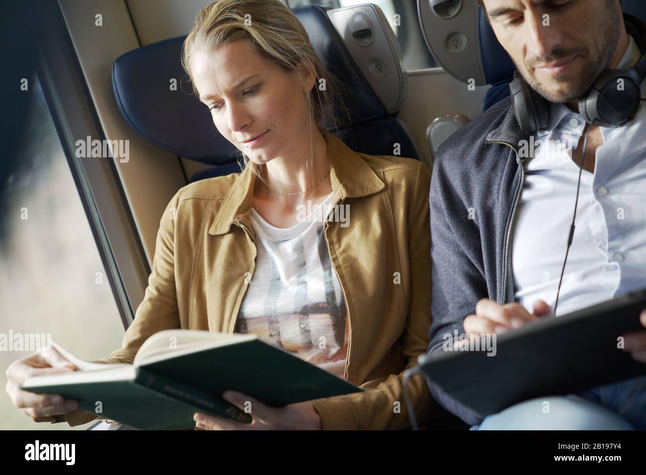 couple traveling in a train Stock Photo - Alamy