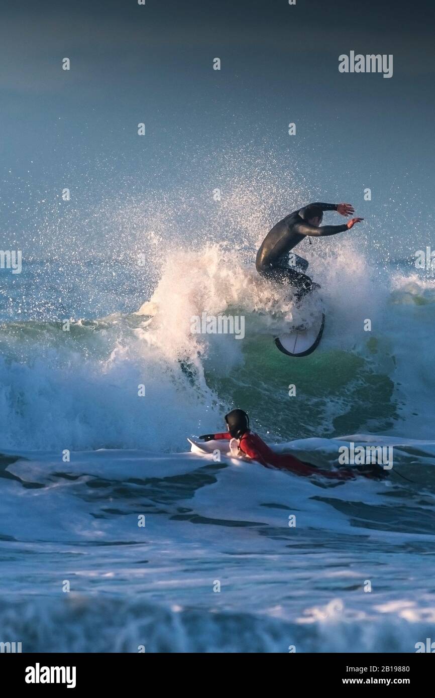 Spectacular surfing action as a surfer rides the crest of a wave at ...