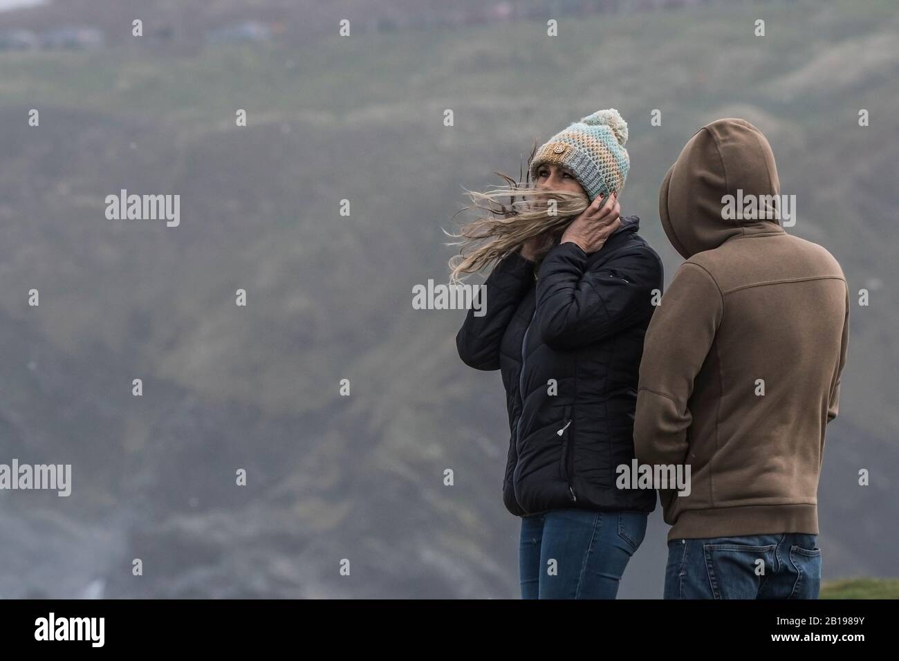People standing very windy weather conditions in the UK Stock Photo - Alamy