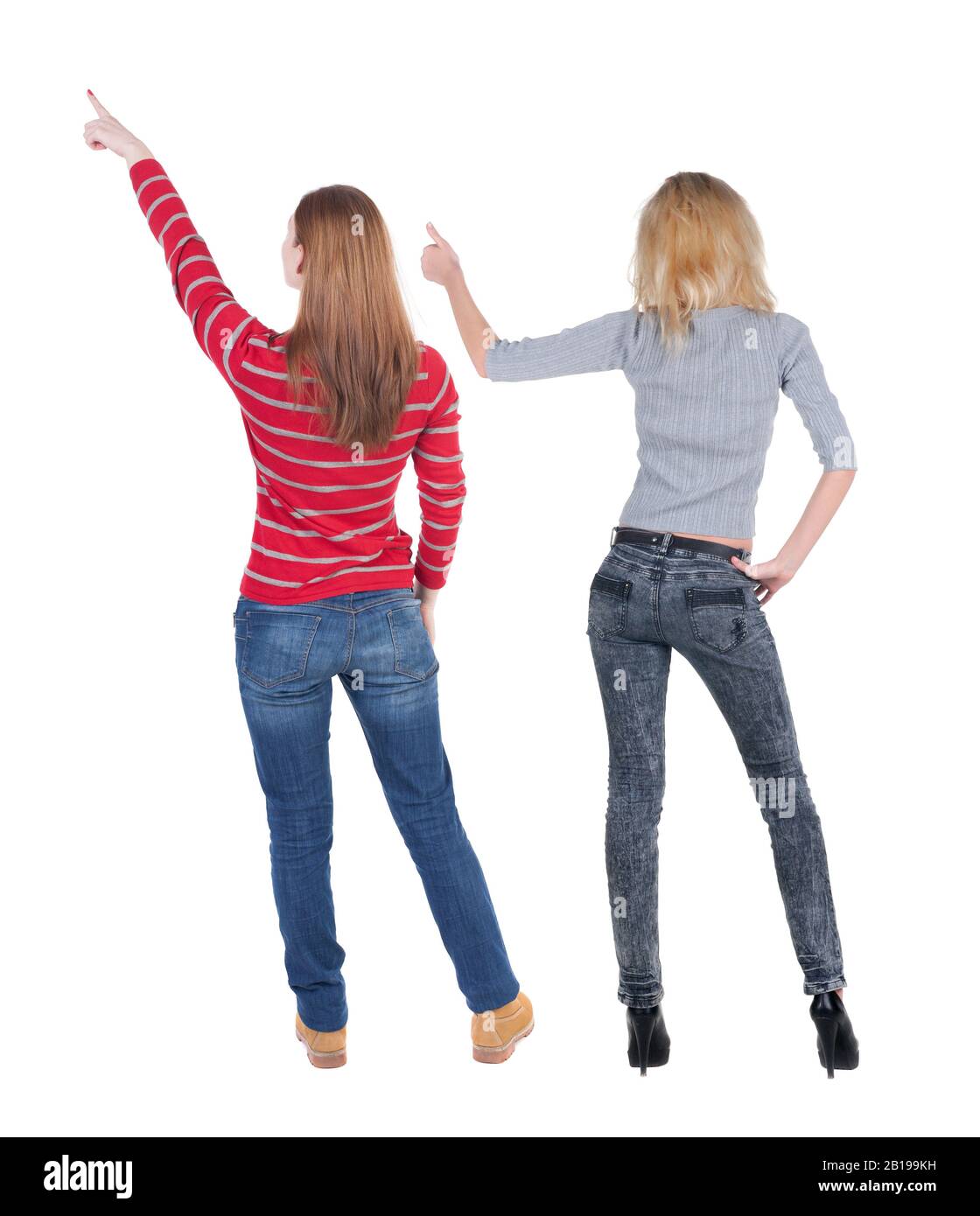 Back view of two pointing girl in sweater. Rear view people collection ...