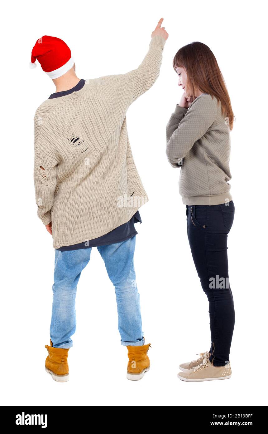 Back view of couple couple in sweater pointing. Rear view people ...