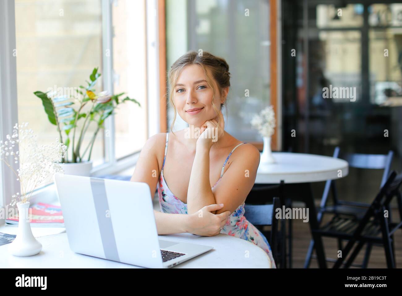 Female student sitting at cafe and surfing internet by laptop Stock ...