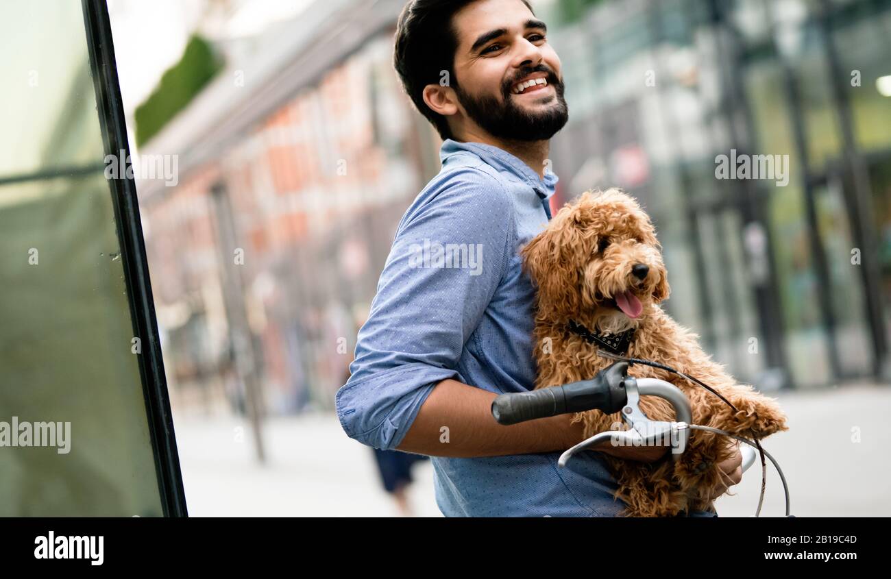 Cropped image of handsome young man with dog Stock Photo - Alamy