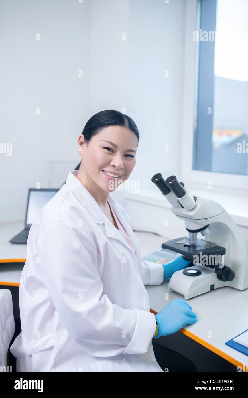 Worker of biochemical laboratory sitting at the table Stock Photo - Alamy