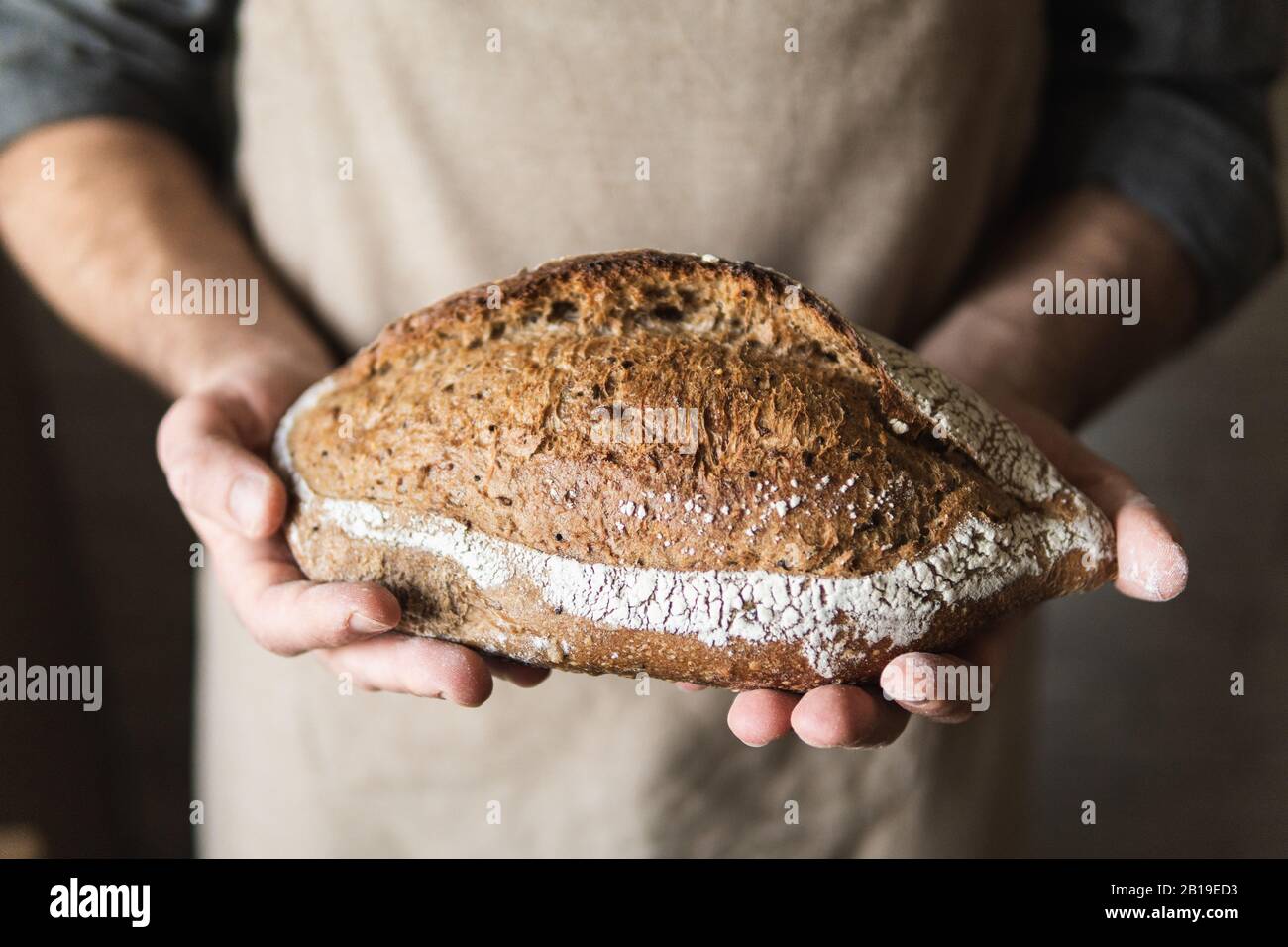 Holding a loaf of bread in his hands hi-res stock photography and ...