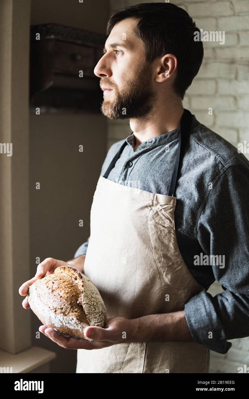 Holding a loaf of bread in his hands hi-res stock photography and ...