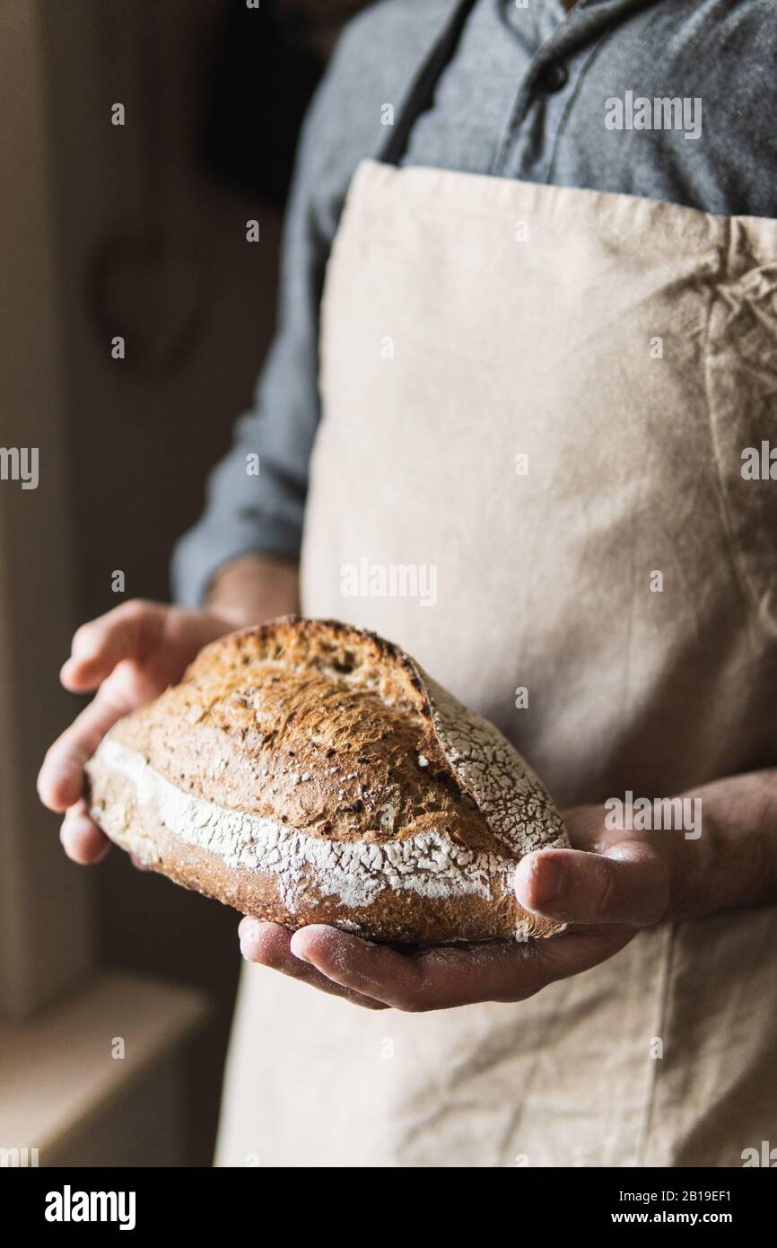 Holding a loaf of bread in his hands hi-res stock photography and ...