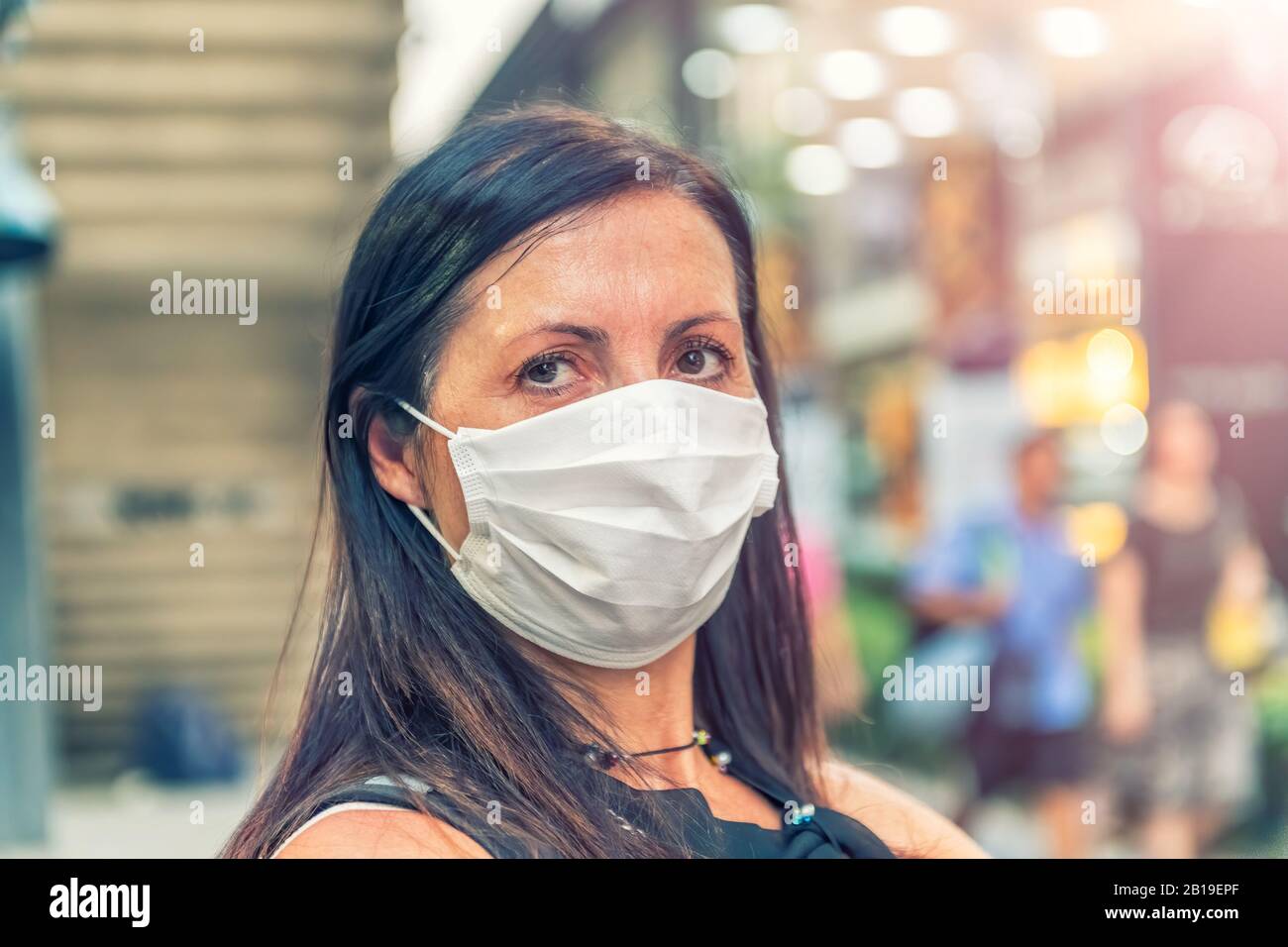 Fear of Coronavirus. Worried woman wearing mask to avoid virus ...