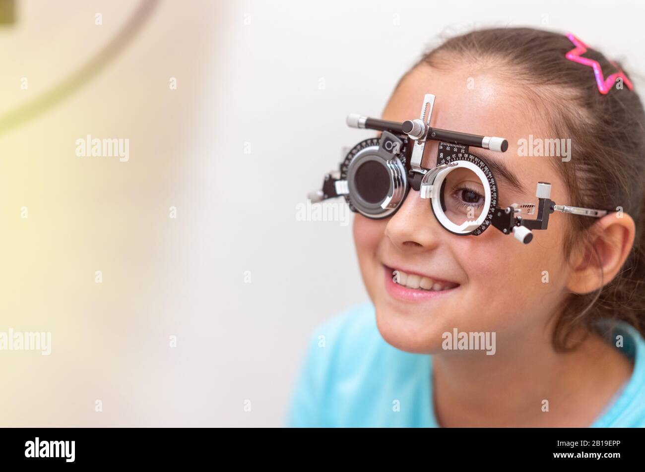 Try-on tool for vision check for the young girl patient in front of the ...