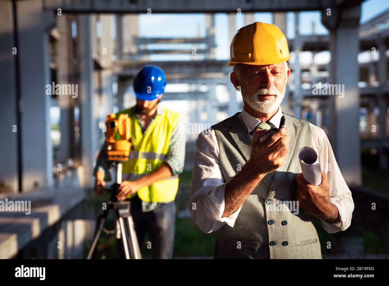 Team of construction engineers, architects working on building site ...