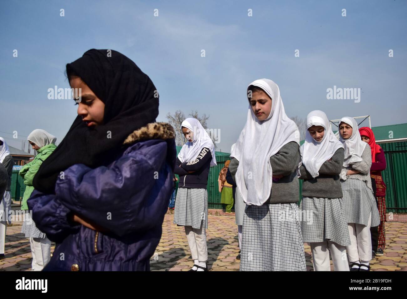 A Kashmiri student prays during a morning assembly in their school premises on the first day of ...