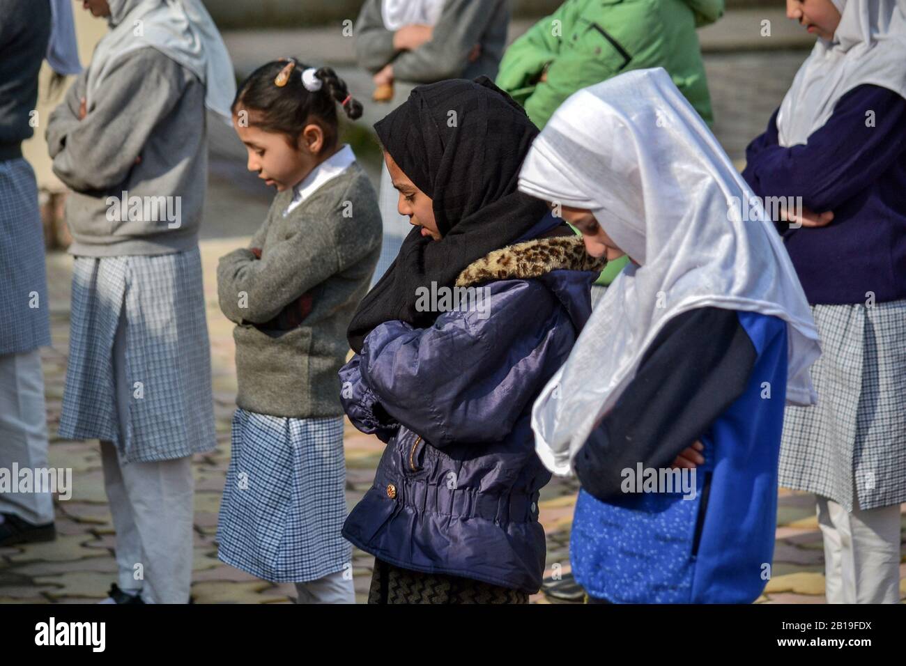 A Kashmiri student prays during a morning assembly in their school premises on the first day of ...