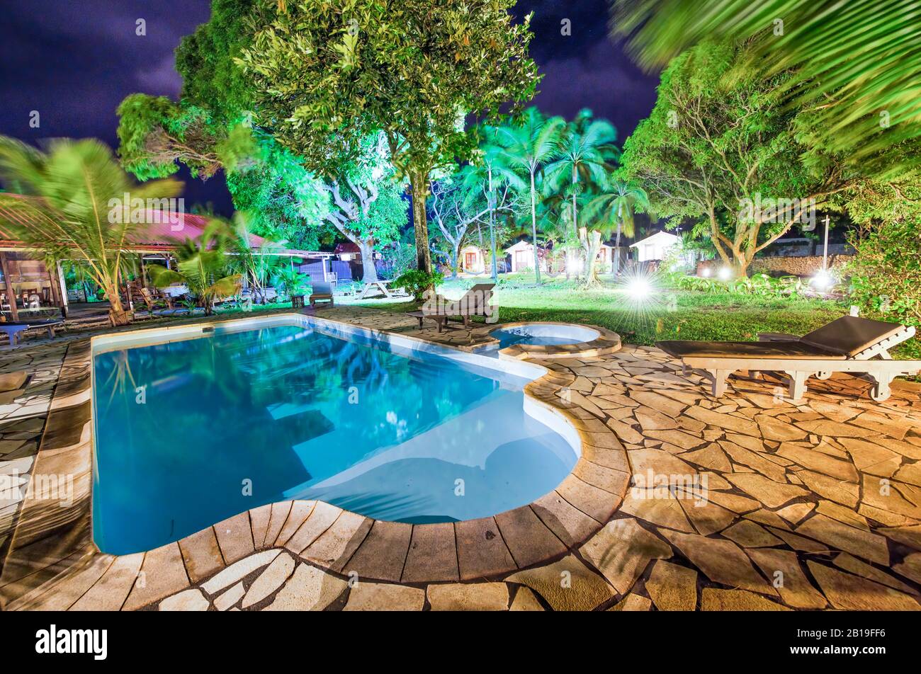 Beautiful garden with trees, pool and grass at night Stock Photo - Alamy