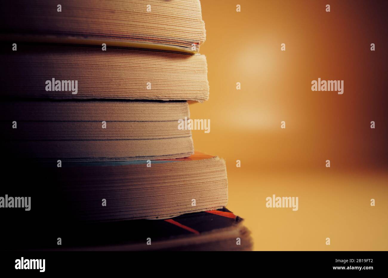 a side view of a pile of books Stock Photo - Alamy