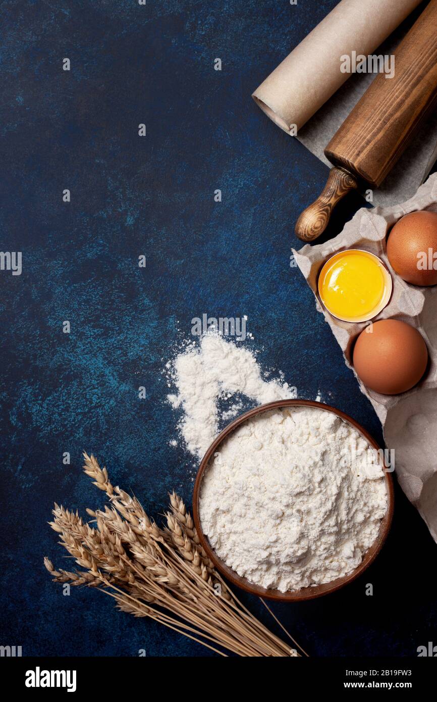 Baking background with eggs and flour on a blue background. view from ...
