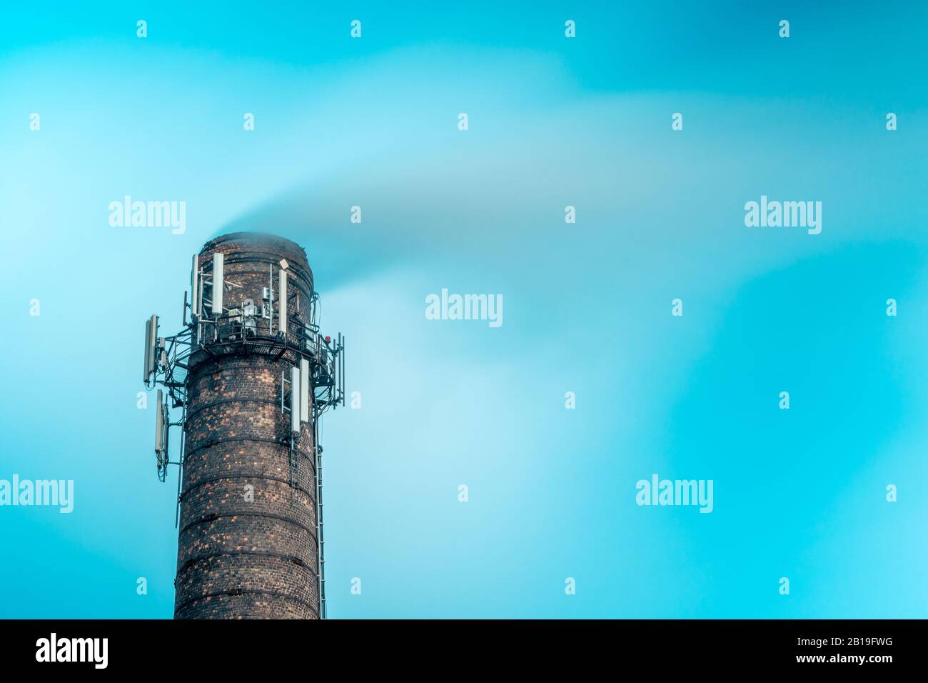 Top of high industrial chimney with multiple antennas. Factory chimney ...