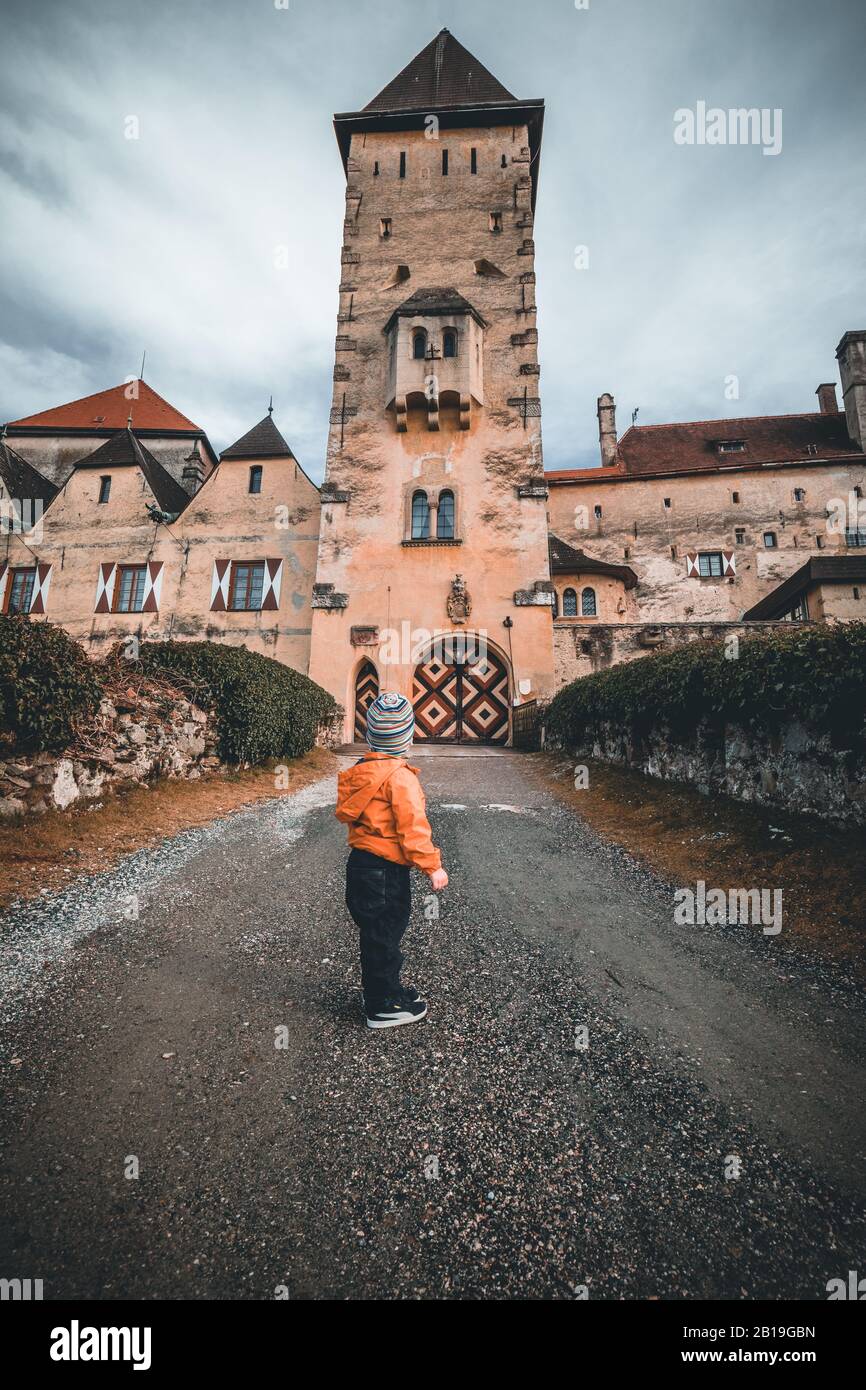 little boy is standing in front of a castle Stock Photo - Alamy