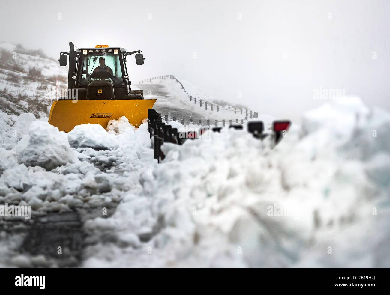 A JCB clears snow from Cliff Gate Road near Thwaite in the Yorkshire ...
