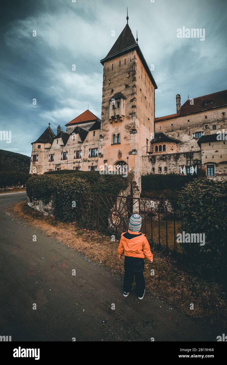 little boy is standing in front of a castle Stock Photo - Alamy
