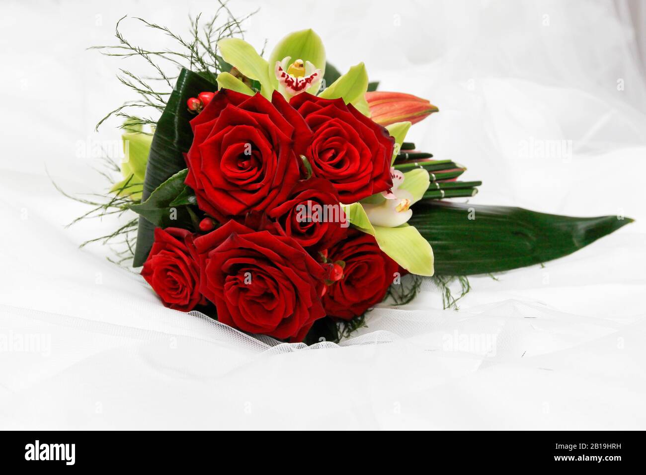 Bouquet of red roses and orchids on white background Stock Photo - Alamy