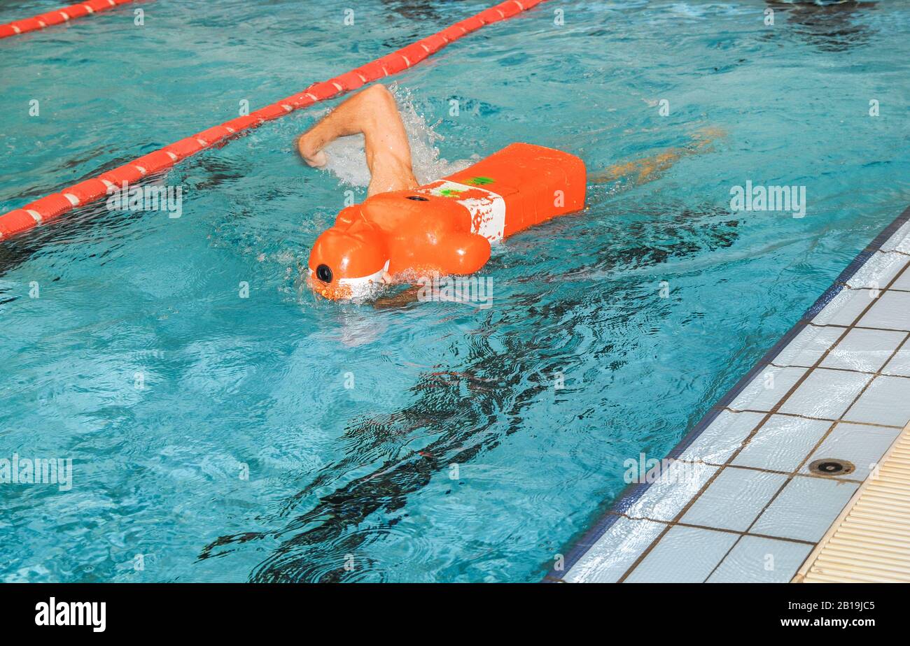 Lifeguard training with rescue dummy in a pool Stock Photo - Alamy