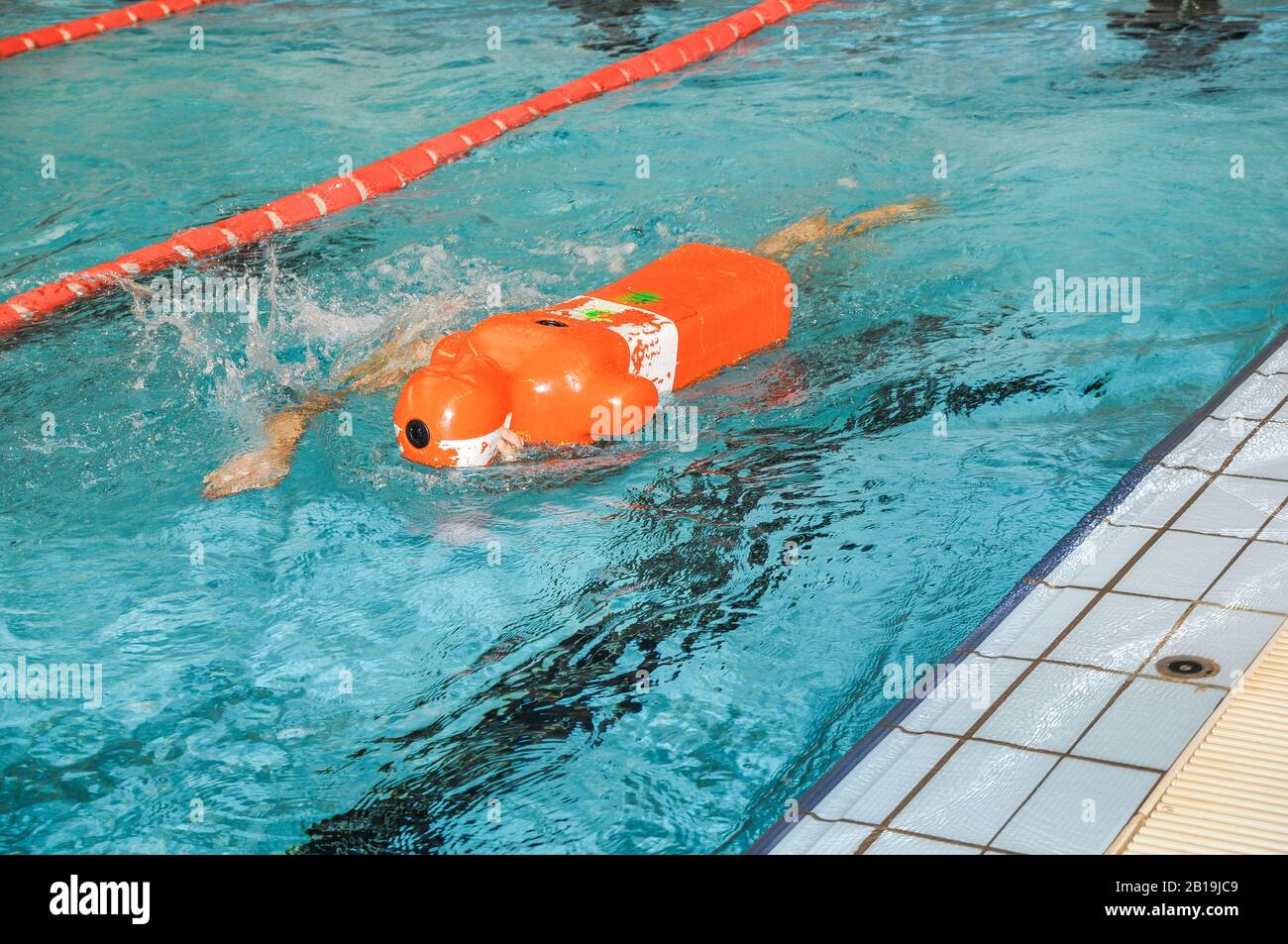 Lifeguard training with rescue dummy in a pool Stock Photo - Alamy