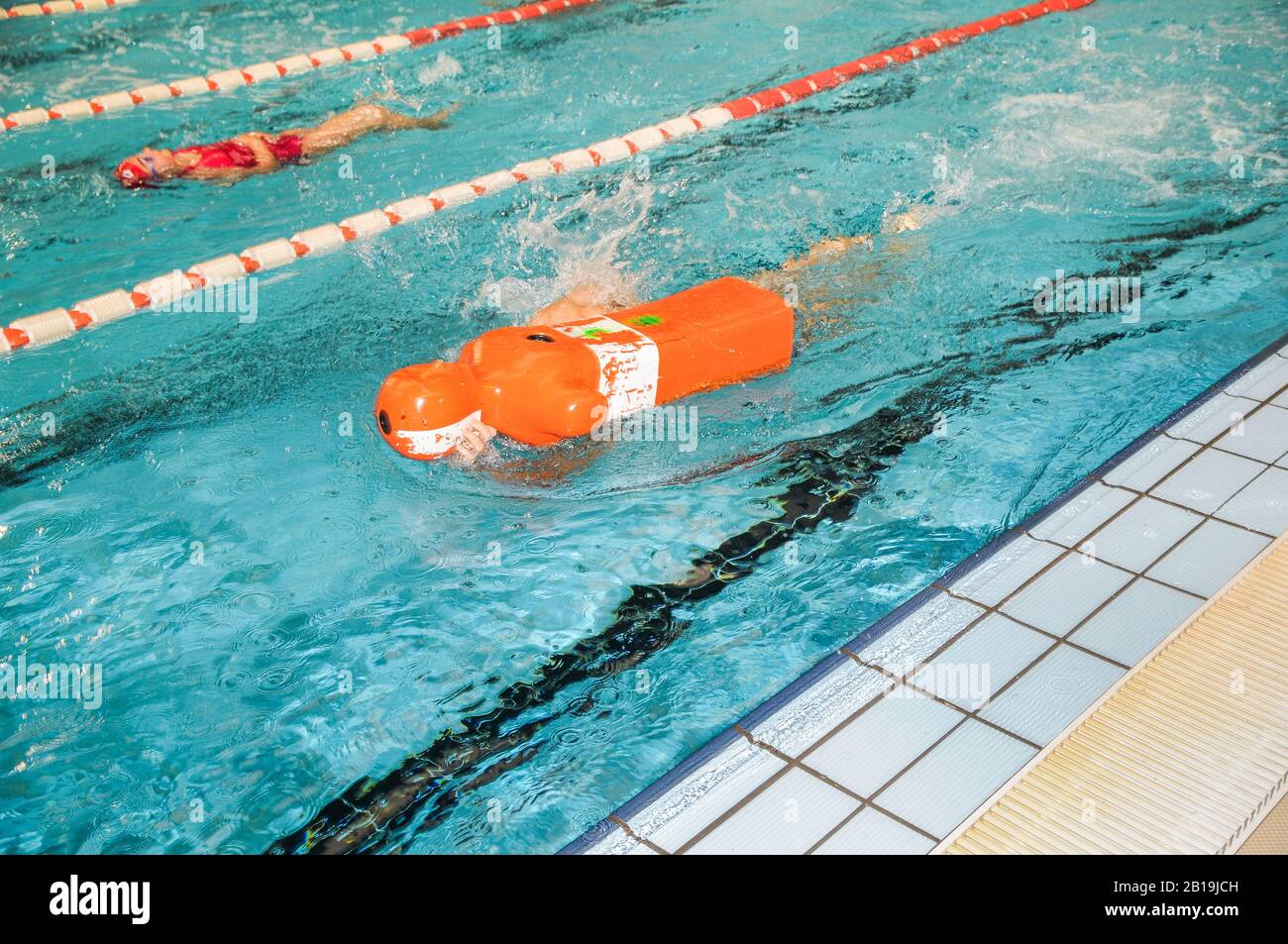 lifeguard training with rescue dummy in a pool Stock Photo - Alamy