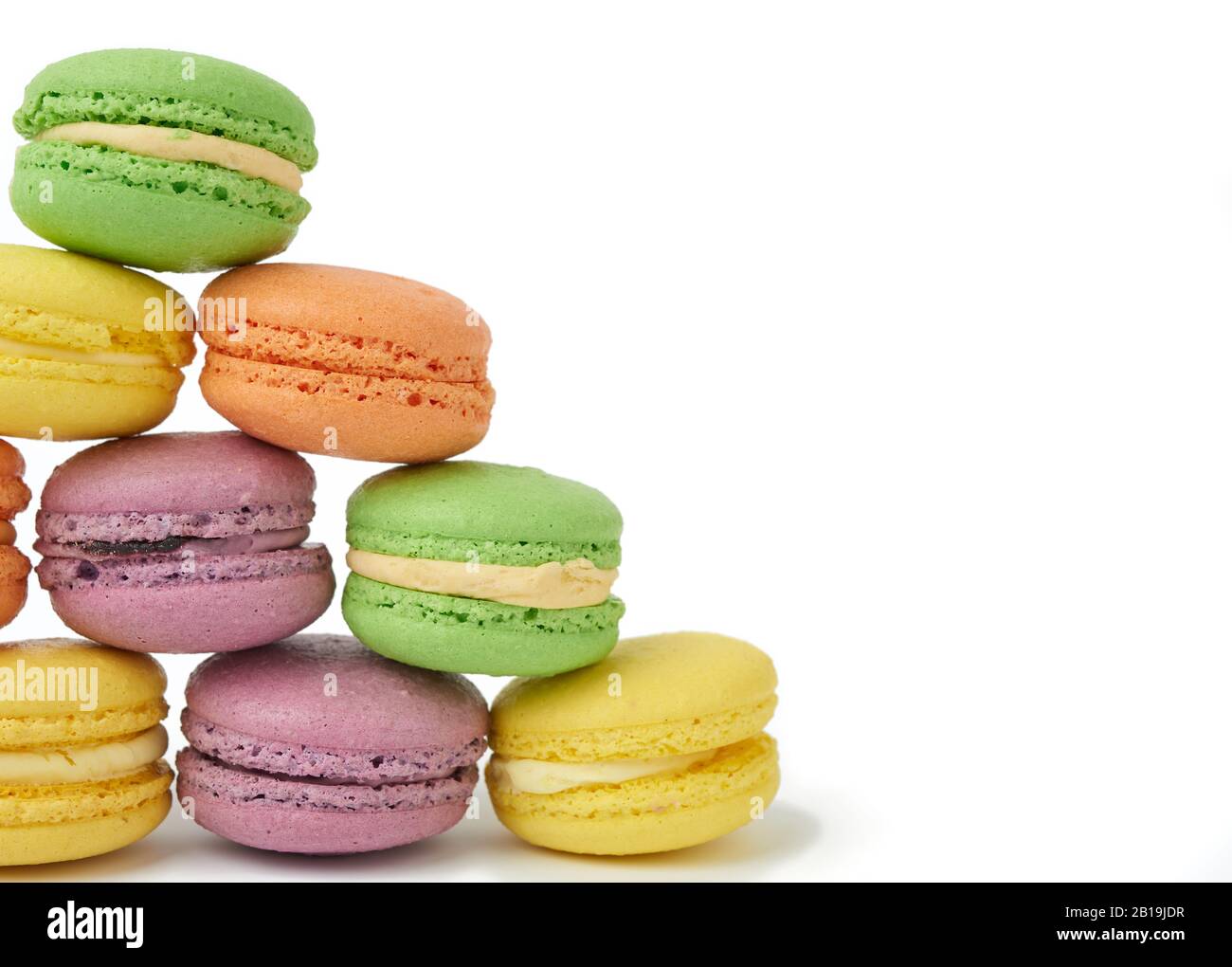 round baked multi-colored almond flour cakes macarons, dessert is laid ...