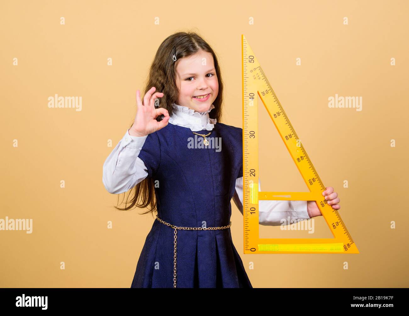 Smart and clever concept. Pupil cute girl with big ruler. School ...