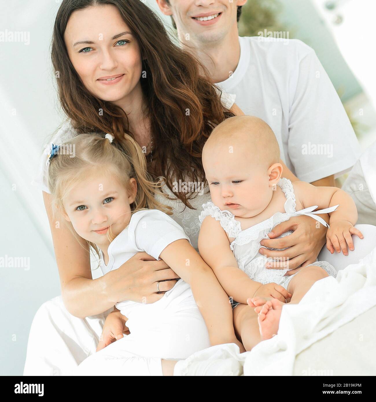 loving parents with two young children on Sunday morning Stock Photo ...
