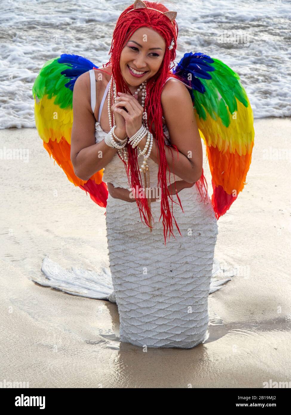 Woman cosplay costume dressed as a mermaid posing on the sand at ...