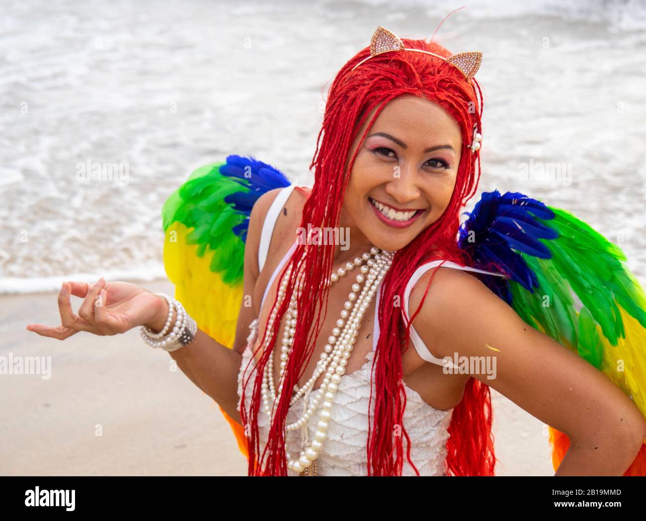Woman cosplay costume dressed as a mermaid posing on the sand at ...