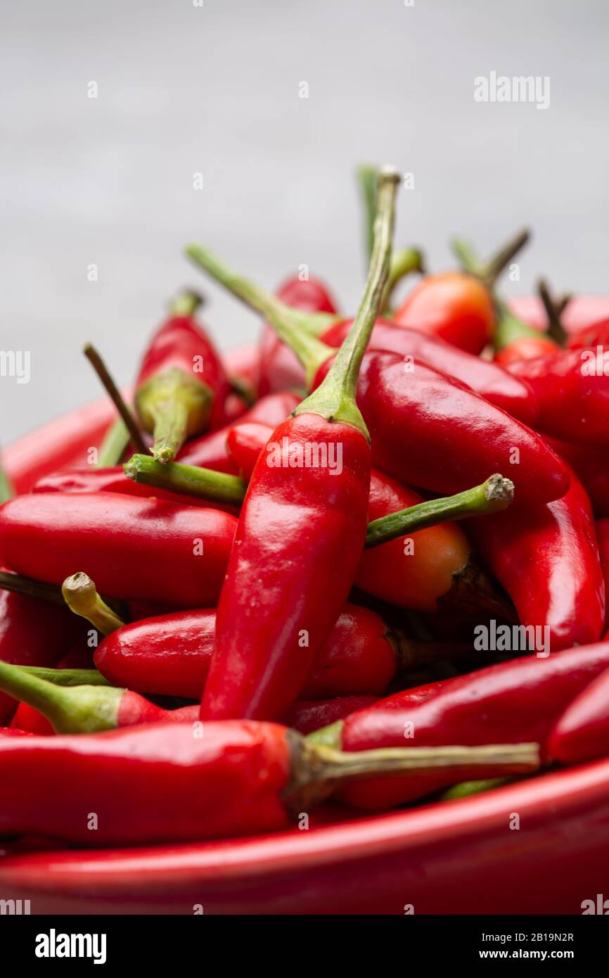 Fresh small red hot chili peppers on grey background close up Stock ...