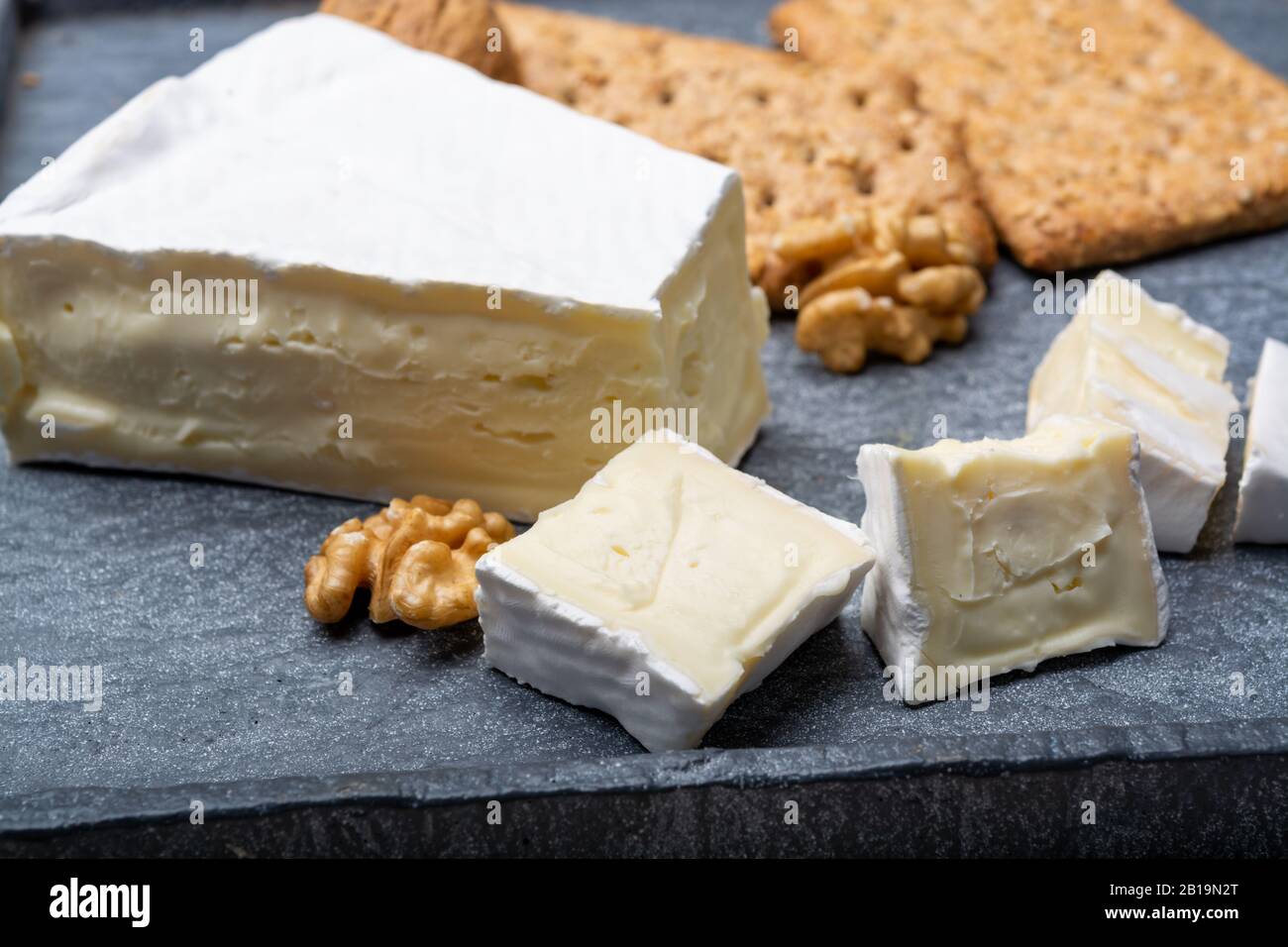 Cheese collection, piece of French brie cheese with white mold close up ...