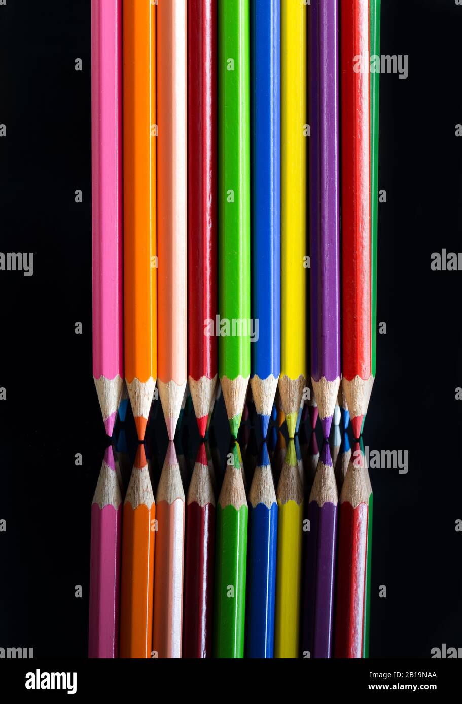 Pile of multicolored wooden crayon isolated on the black background ...