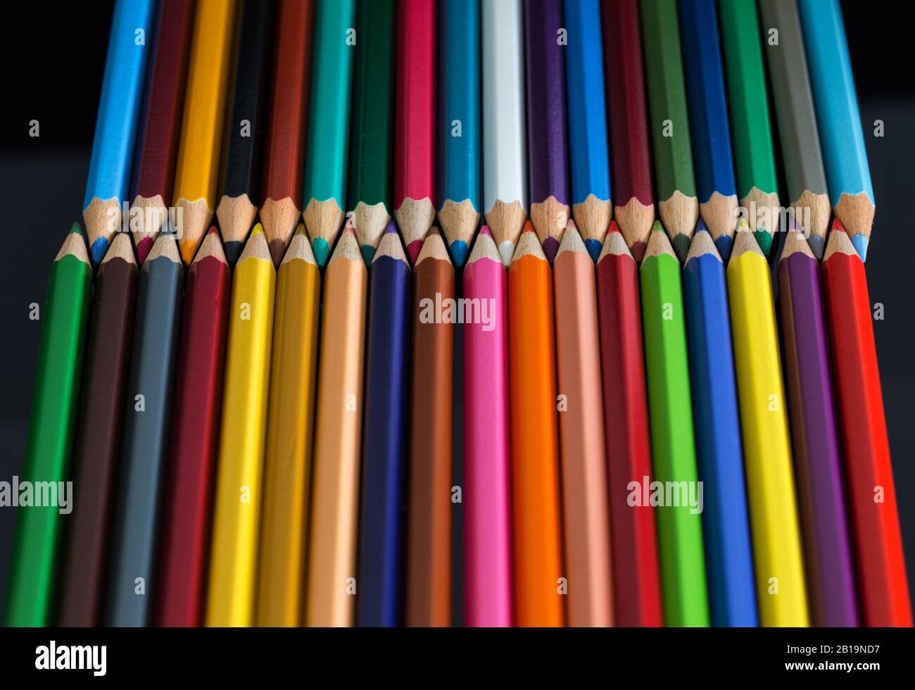 Pile of multicolored wooden crayon isolated on the black background ...