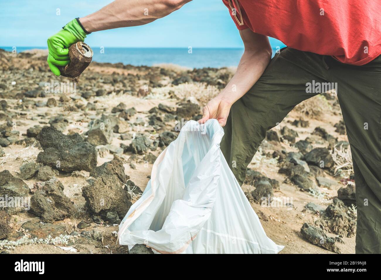 People cleaning the beach from plastic and rubbish - Volunteers at work ...