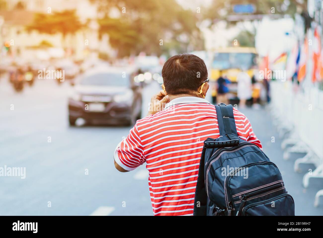 Back view of male patient with mask in red and white shirt with a black ...