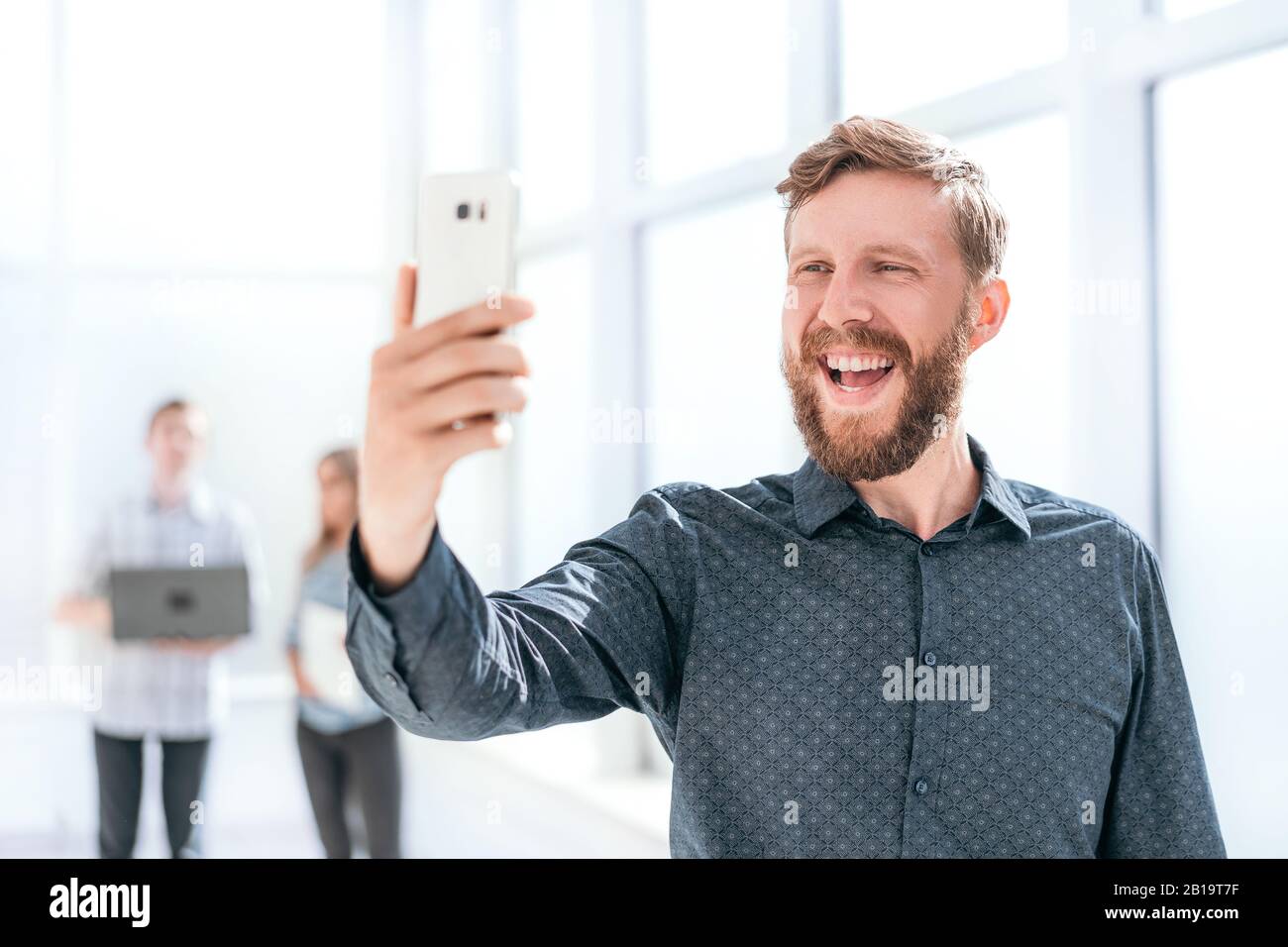 handsome man takes a selfie in the office lobby Stock Photo - Alamy