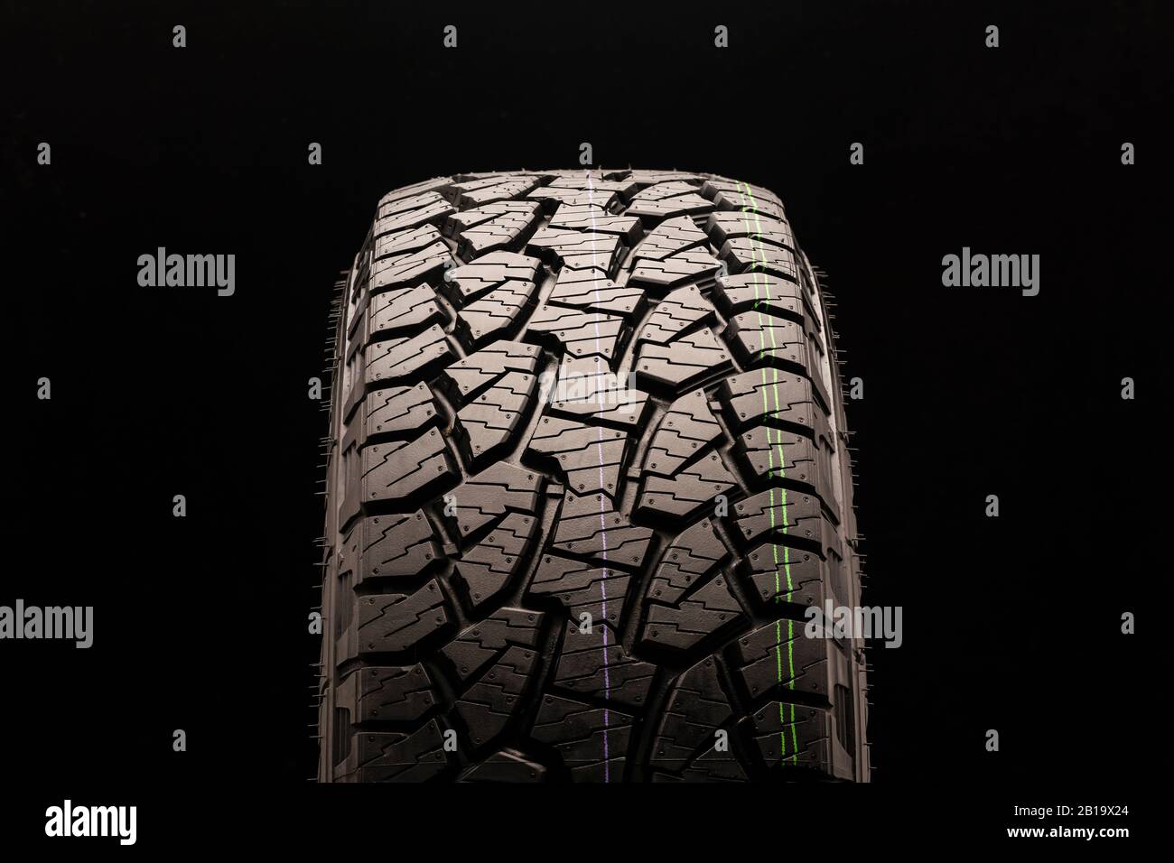 mud all terrain tires for SUVs on a black background close-up. front ...
