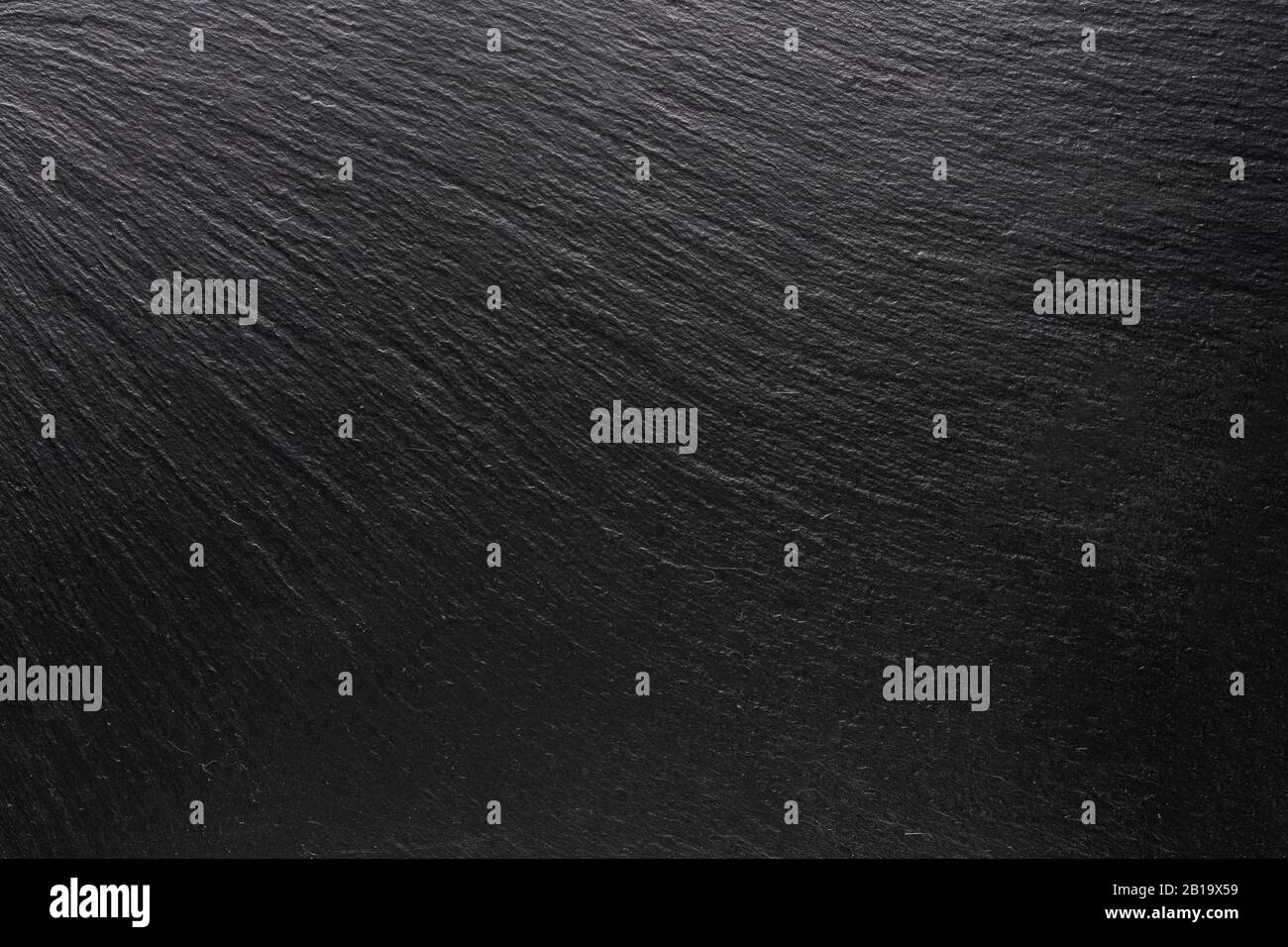 black stone, texture for the background. smooth shadows and light on ...