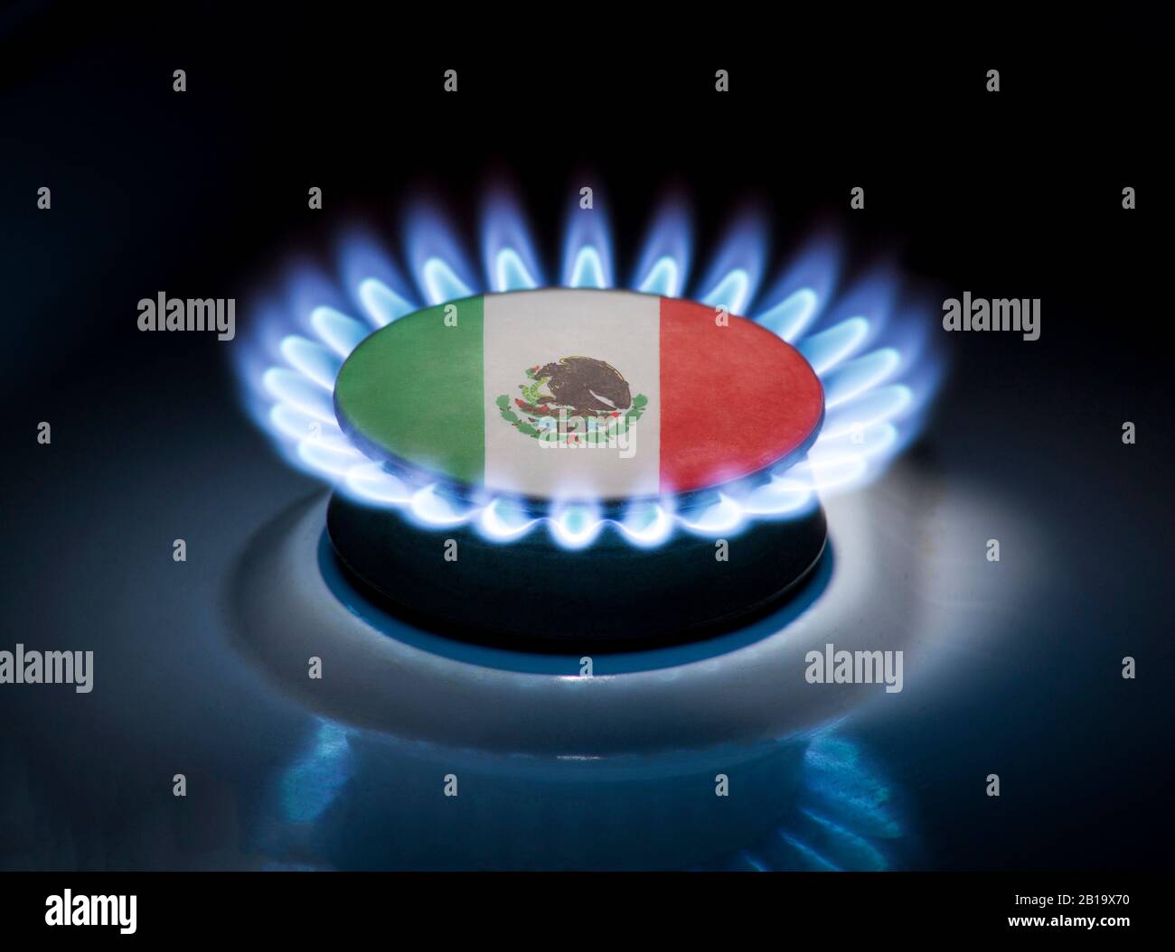 Burning gas burner of a home stove in the middle of which is the flag ...