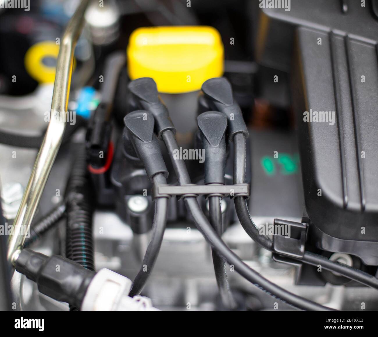 distributor in a car with high-voltage wires in the engine compartment ...