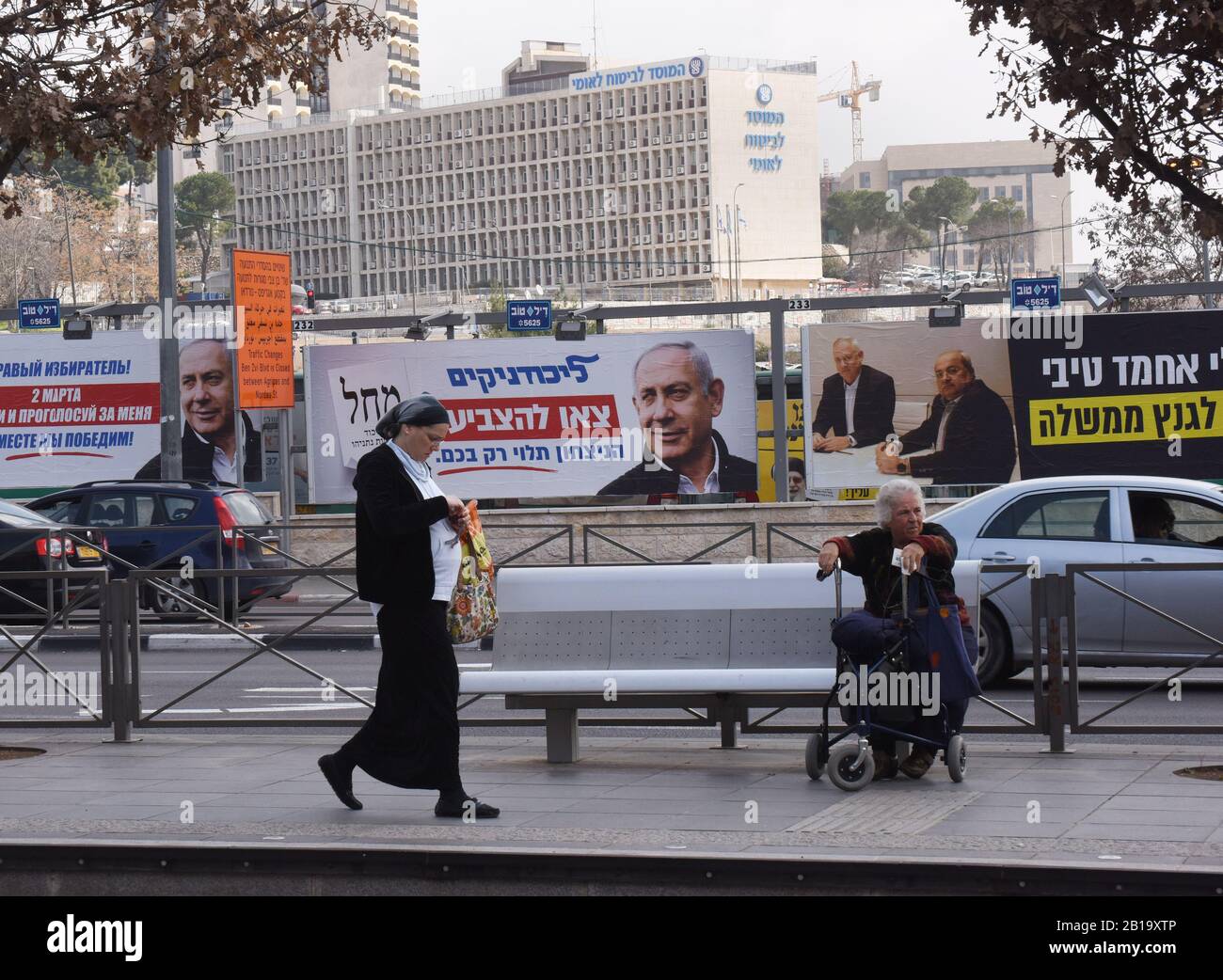 Jerusalem, Israel. 24th Feb, 2020. An Israeli walks past election ...