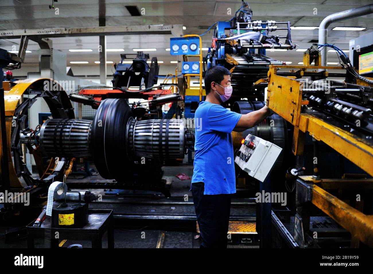 A Chinese worker manufactures rubber tires at the plant of Sailun Group ...