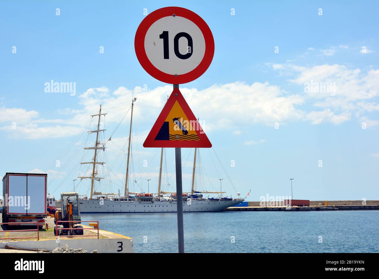 Greece, Kavala, warning sign and sailing ship in harbor Stock Photo - Alamy