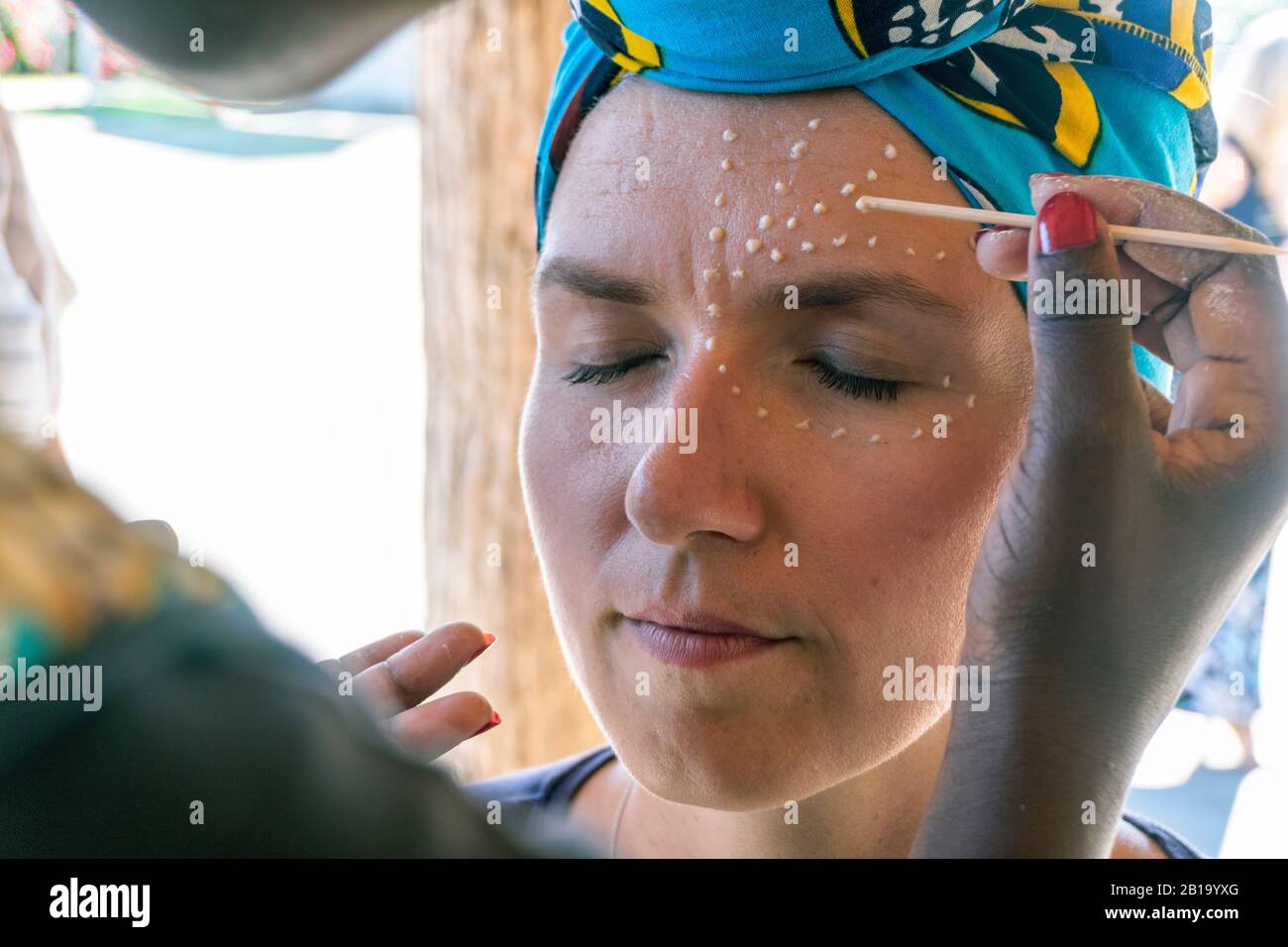 Doing traditional African make up on white woman. The dots are made of ...
