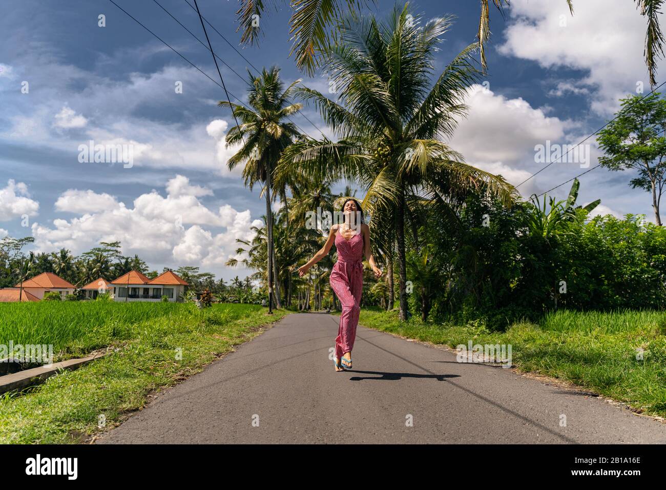 Positive delighted young woman jumping during walk Stock Photo - Alamy