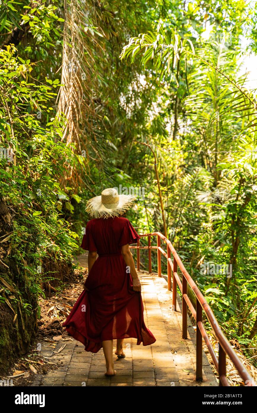 Young tall woman walking in exotic garden Stock Photo - Alamy