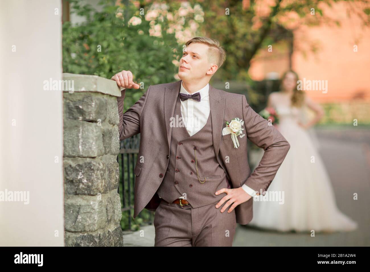 groom waiting for his bride standing on city street Stock Photo - Alamy